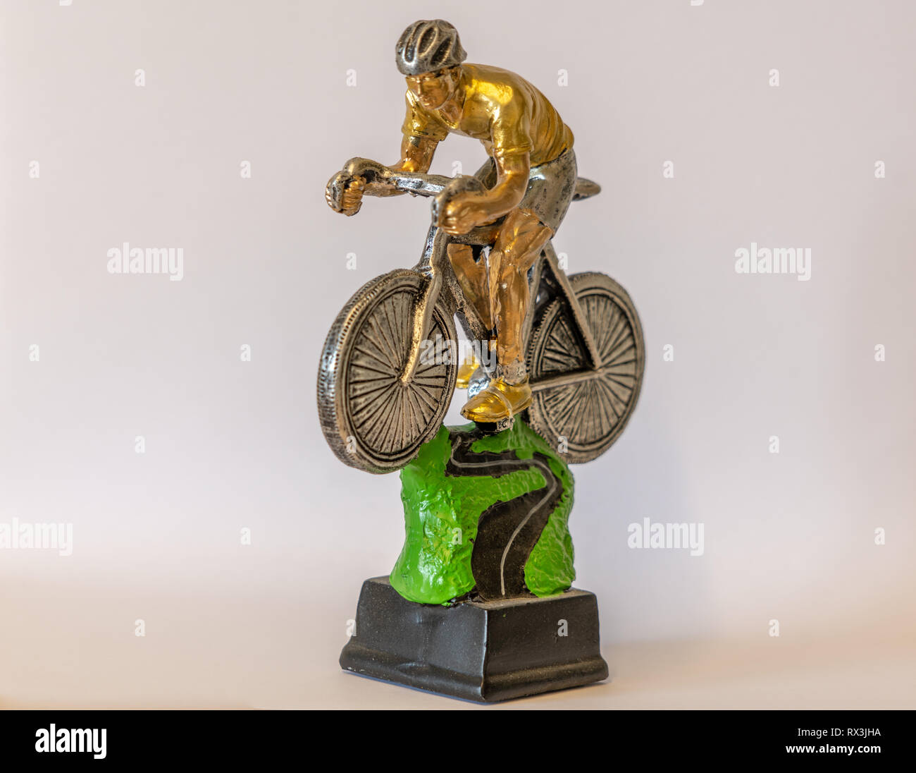 a sports trophy stands in front of a white wall Stock Photo - Alamy