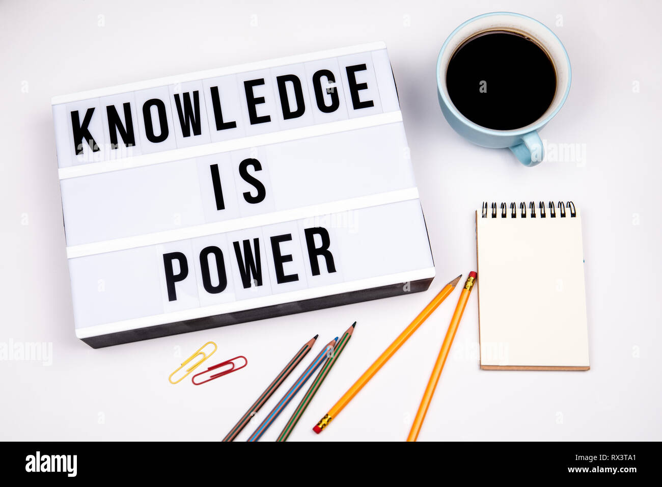 Knowledge is power. Text in lightbox. White desk with stationery Stock ...