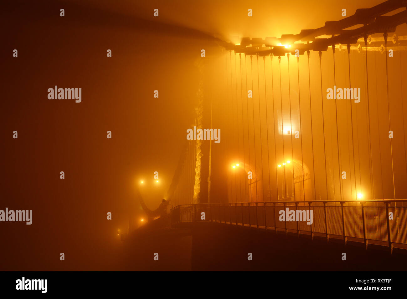 Misty and Foggy Menai Suspension bridge at night time. This bridge ...