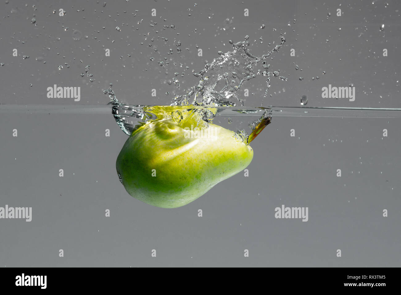 Splashing green drop creates hi-res stock photography and images - Alamy
