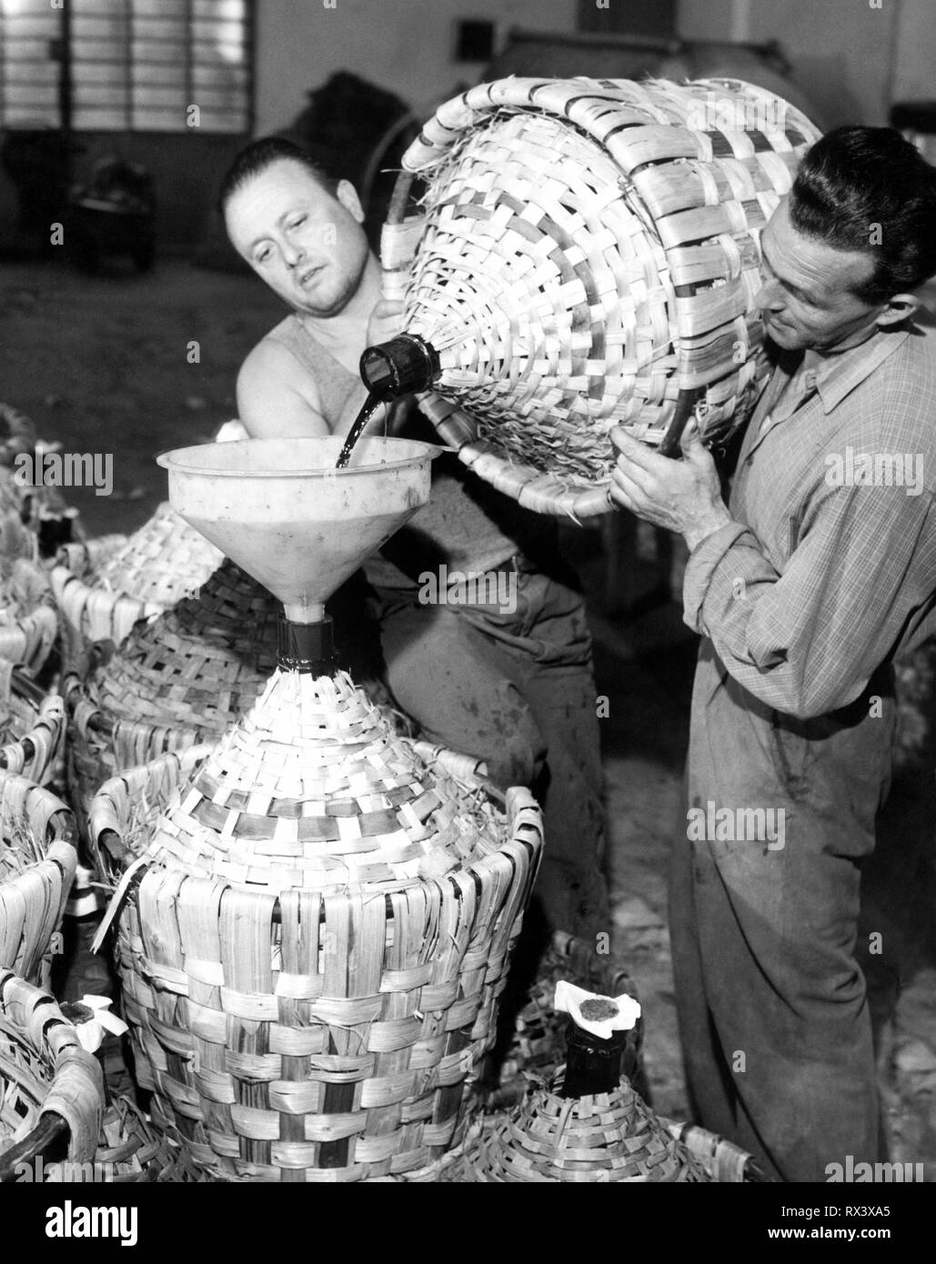 wine decanting in the demijohns, italy 1959 Stock Photo - Alamy