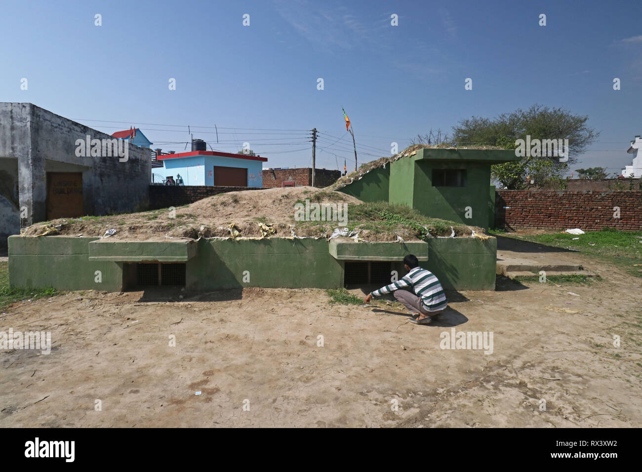 India. 07th Mar, 2019. A man inspecting a bomb proof bunker at a ...
