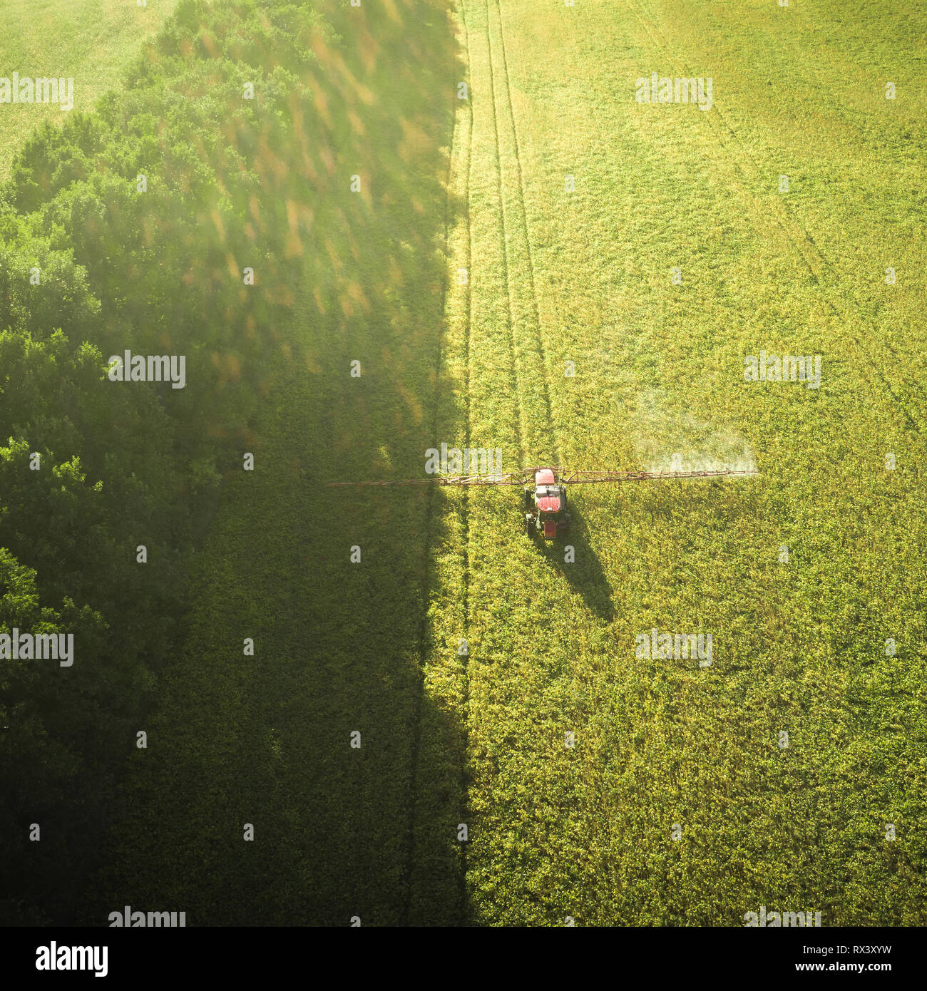 Agricultural machinery in the field. Tractor with a sprayer. Aerial ...