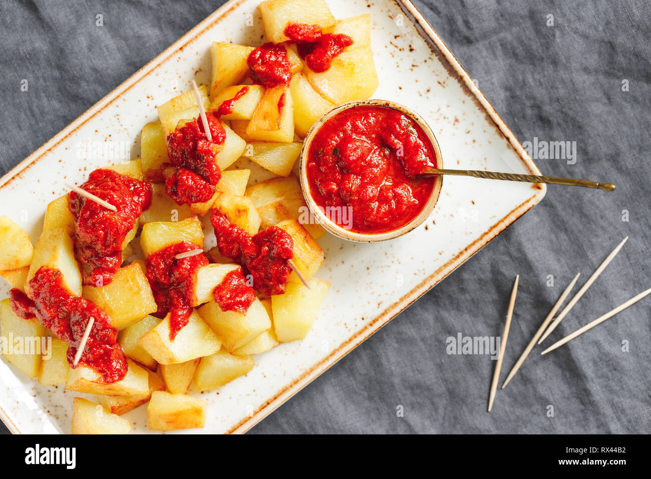Top view on traditional tapas of Spanish cuisine Patatas Bravas. Fried ...