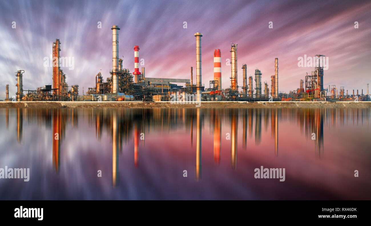 Oil Refinery at sunset with reflection Stock Photo - Alamy