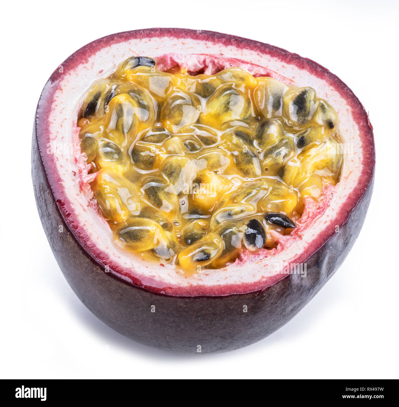Cross section of passion fruit with pulpy juice filled with seeds ...