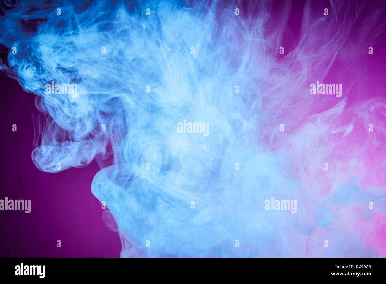 Blue bomb smoke on pink isolated background Stock Photo - Alamy