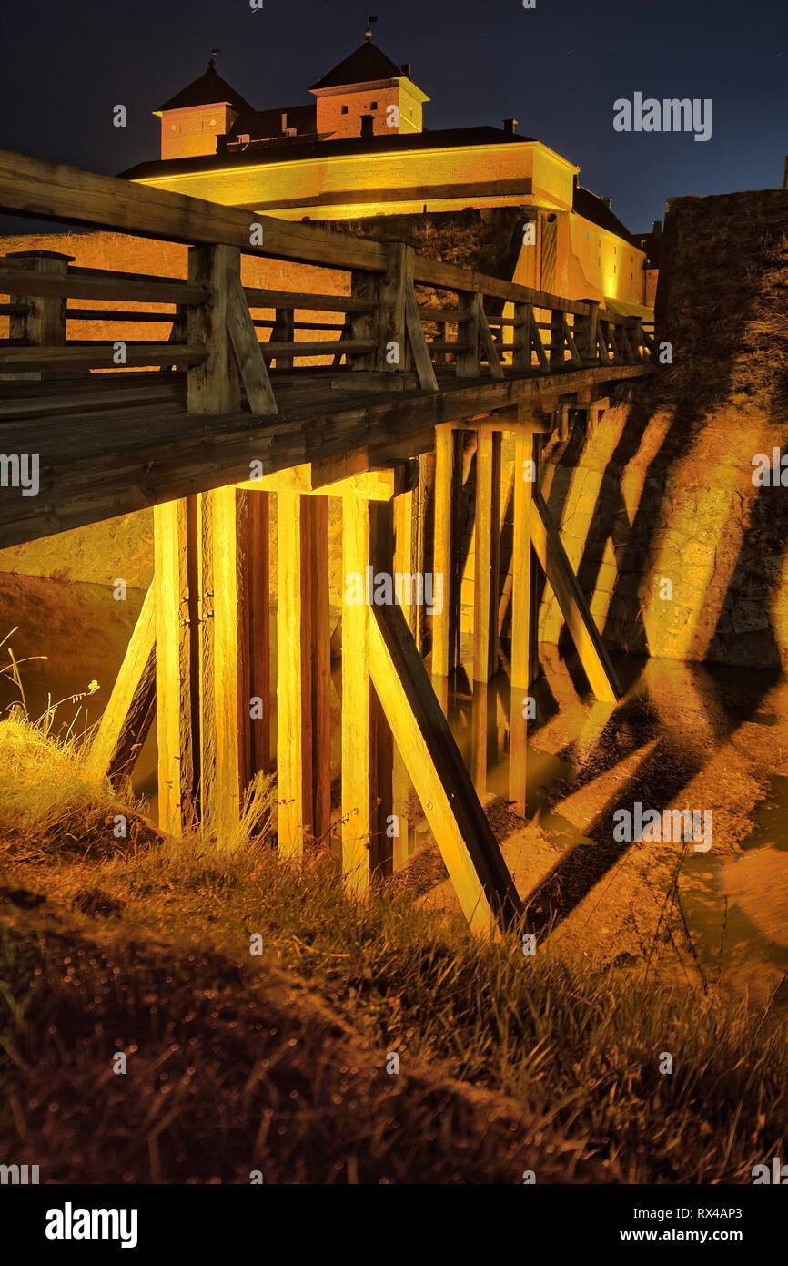 Wooden bridge leading to medieval castle in Finland at night. Very ...