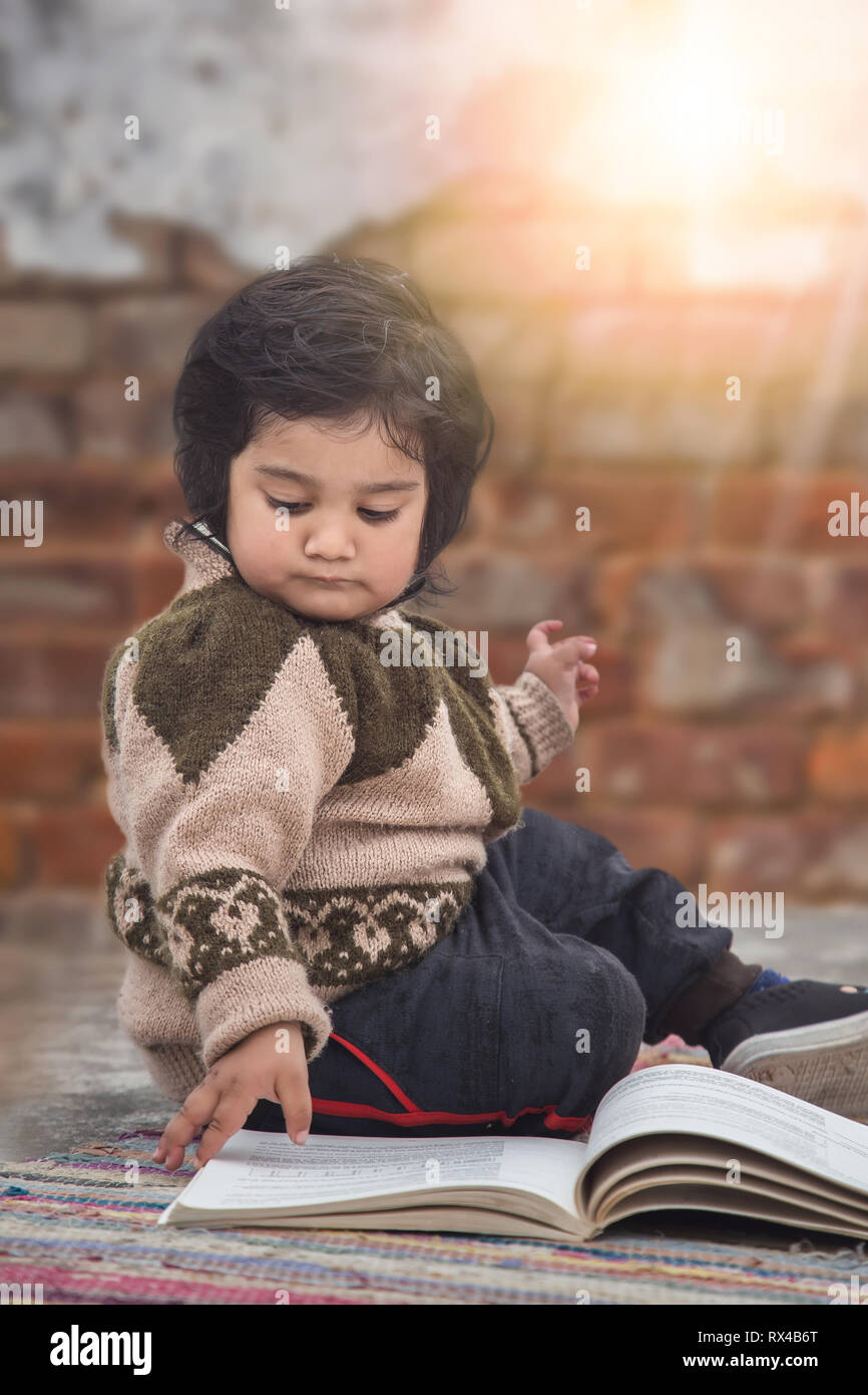 Cute 2 year little Indian Asian girl reading book, Asian girl child ...