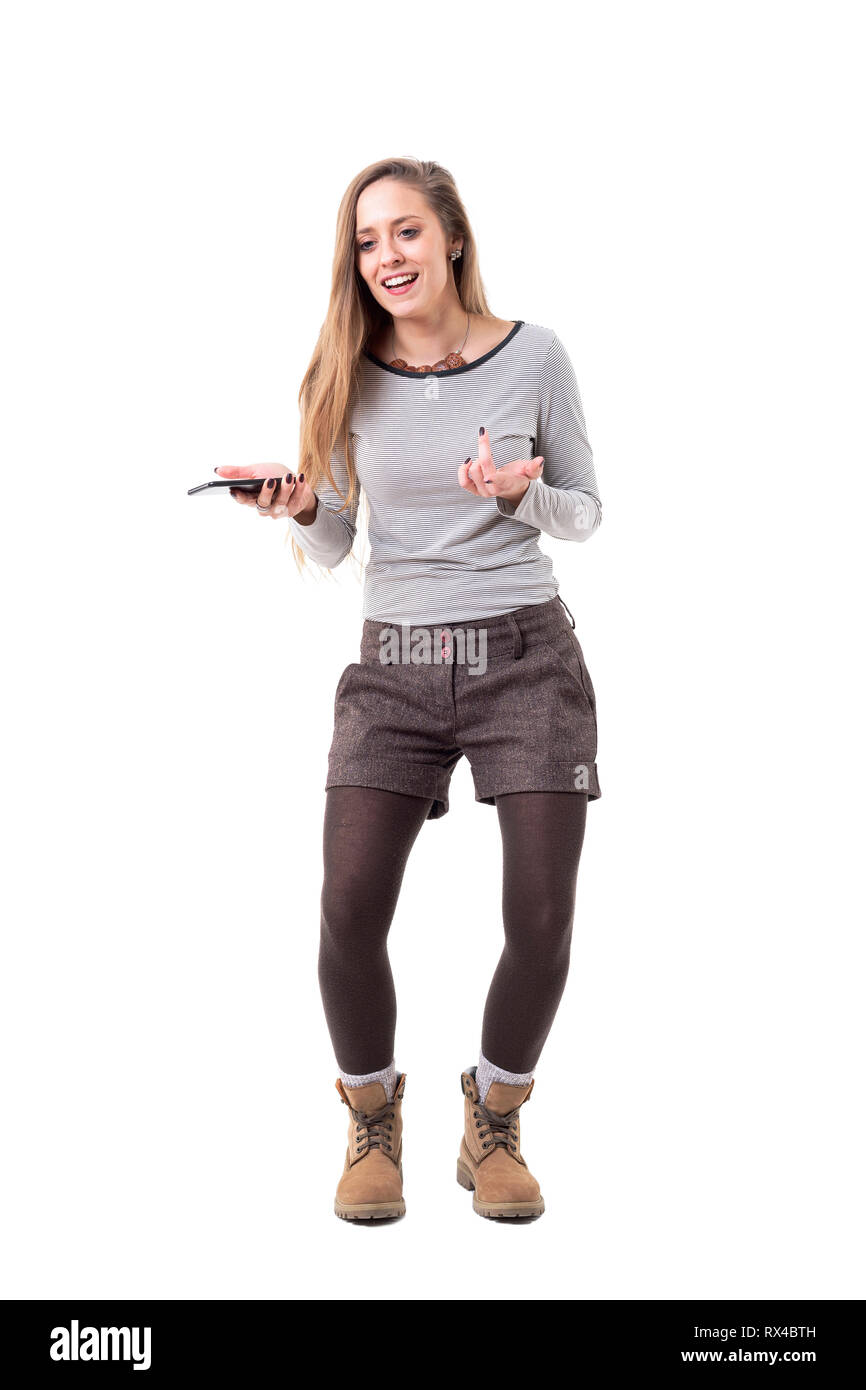 Happy laughing woman talking handsfree on mobile phone speaker. Full ...