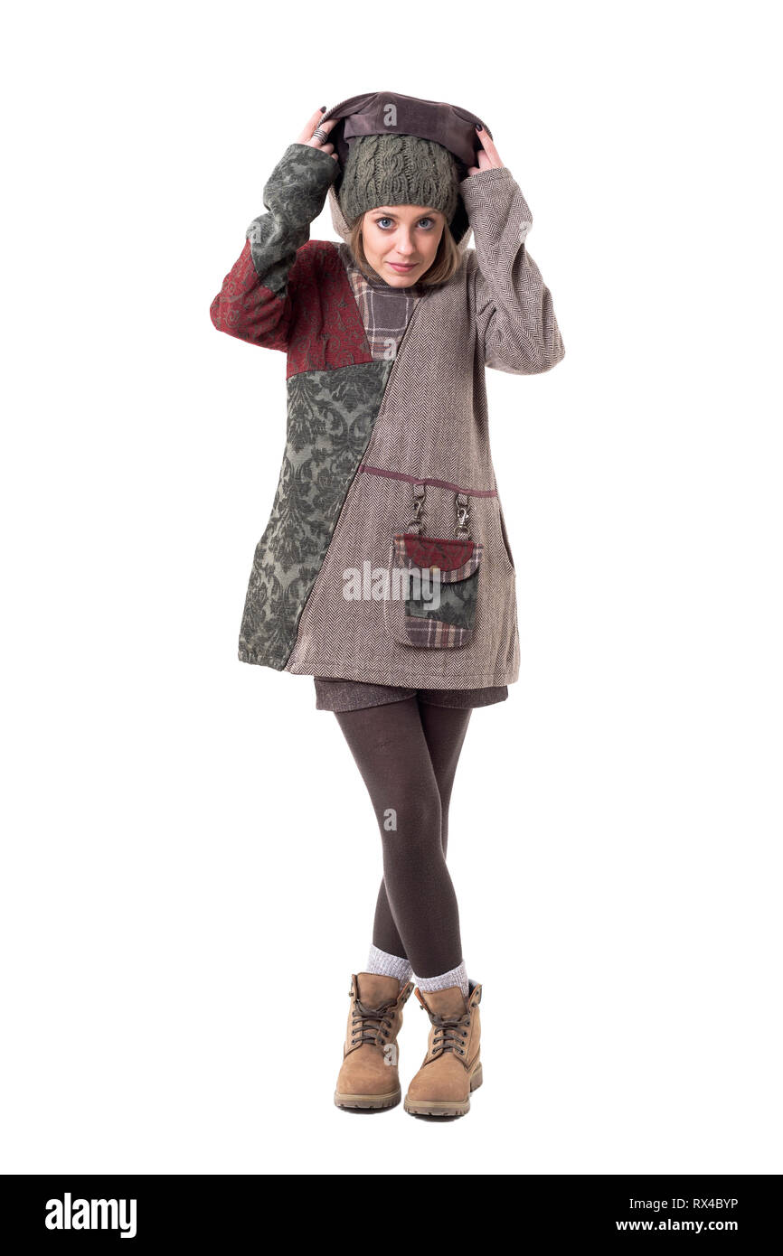 Cute lovely young hipster woman in warm clothes with cap put on hoodie ...