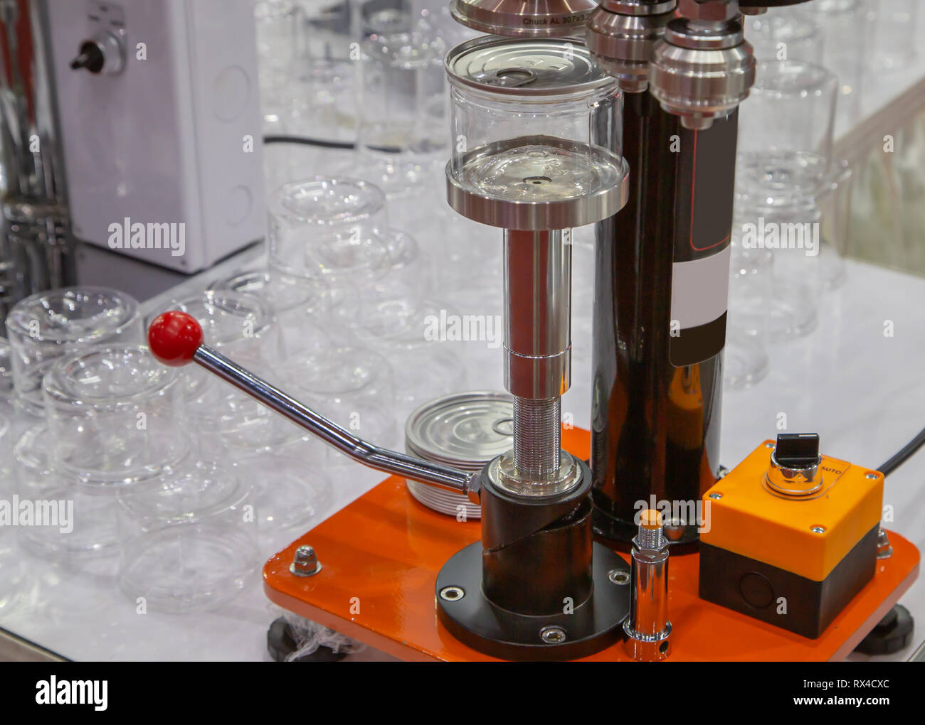 Ring pull can and plastic cap sealing machine Stock Photo - Alamy