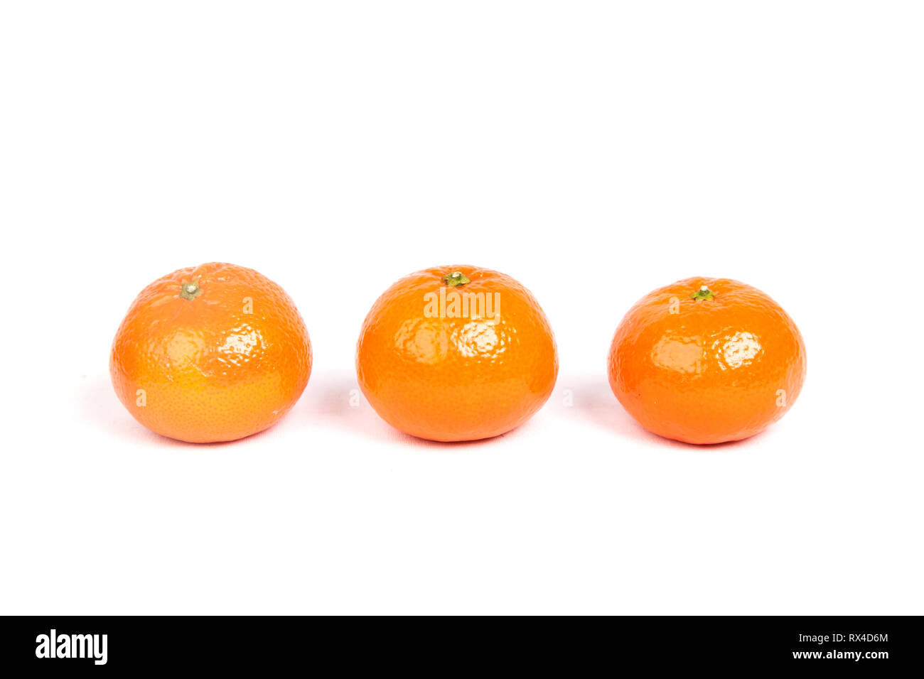 Three small oranges isolated on white background Stock Photo - Alamy