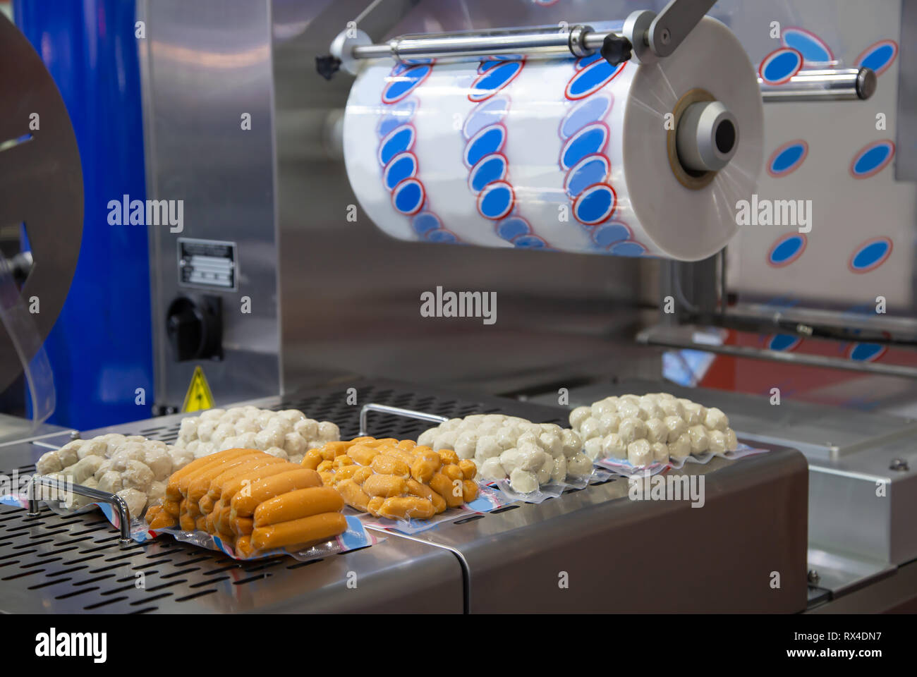 Linear tray food heat sealing and packing machine Stock Photo - Alamy