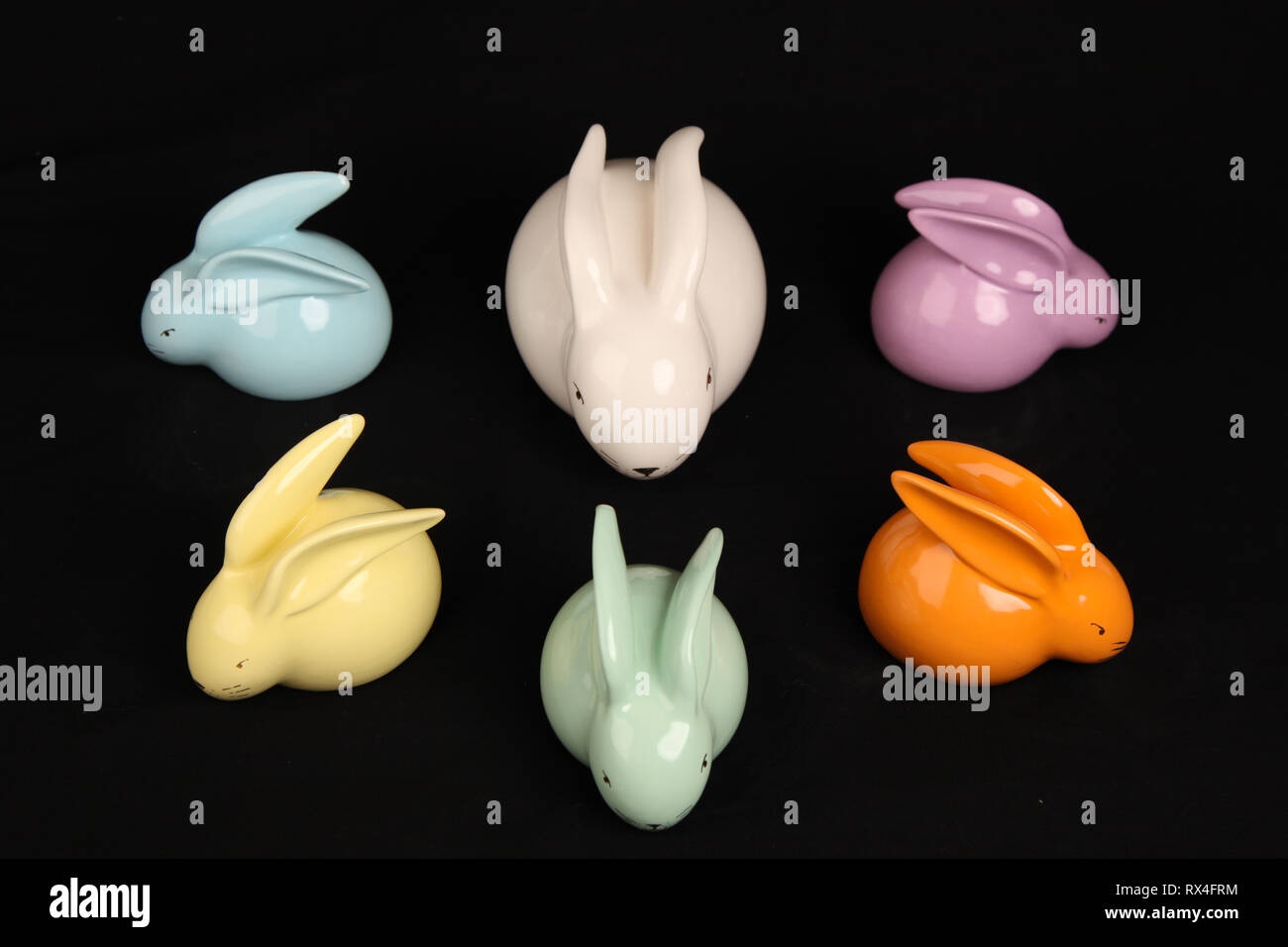 Colourful ceramic rabbits on a black background Stock Photo - Alamy