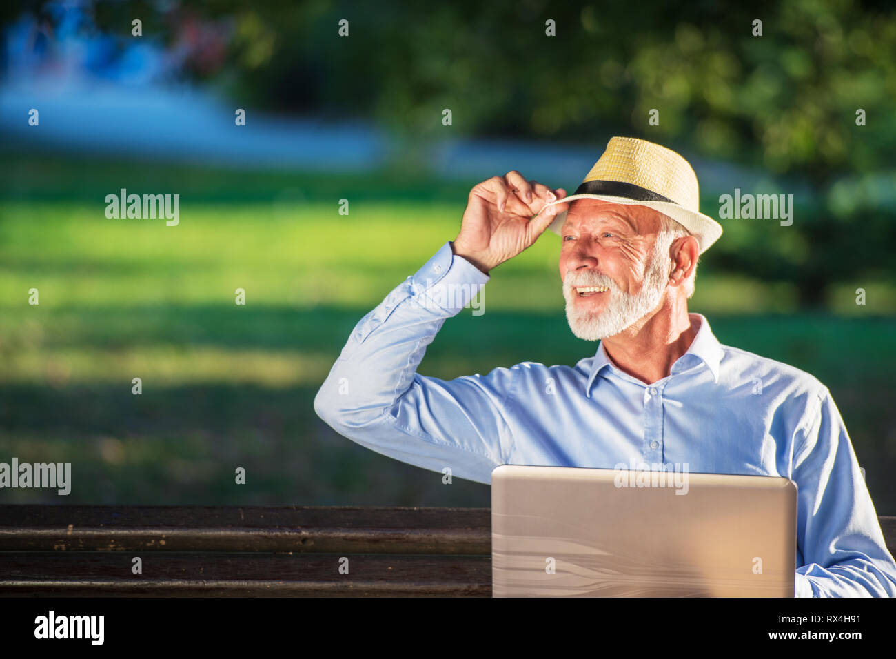 Senior man using laptop computer at rest in the park outdoors Stock ...
