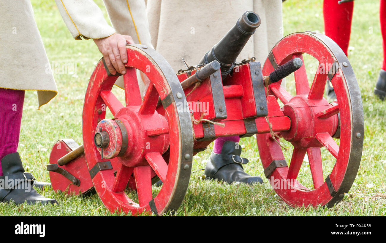 A small red cannon being dragged by the guards. The red cannon is one ...