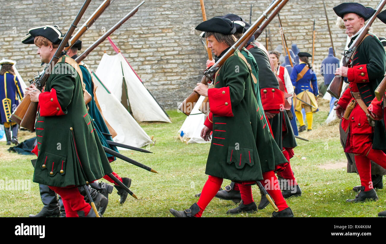 Set of guards are marching following their leader. They are wearing the ...