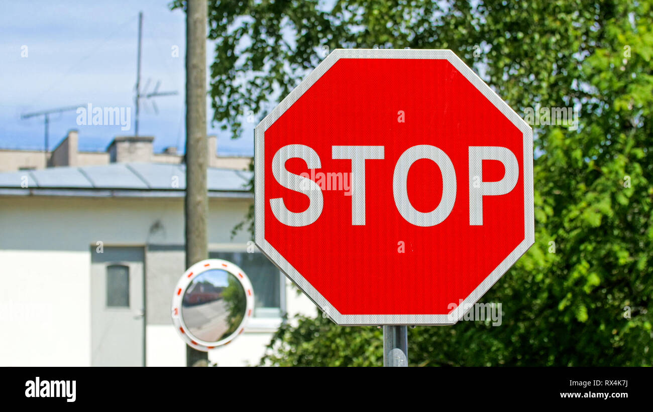 A stop signage on the side of the road. The big red signage helps the ...