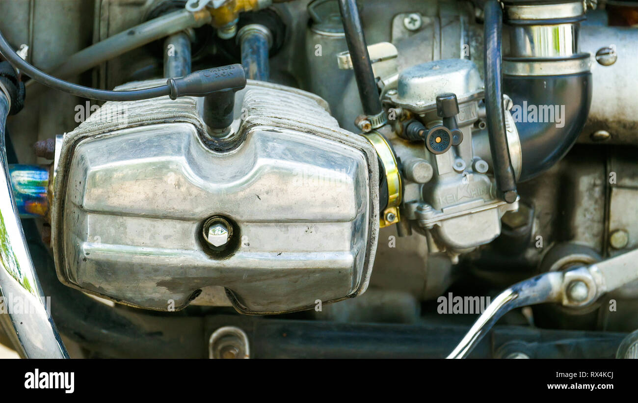 Closer look of the engine of the motor bike. Pipes and hose can be seen ...