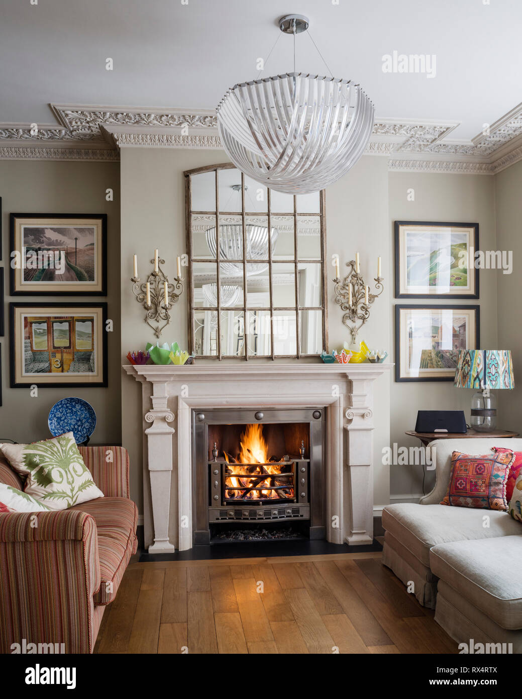 Lit fire in country style living room Stock Photo - Alamy