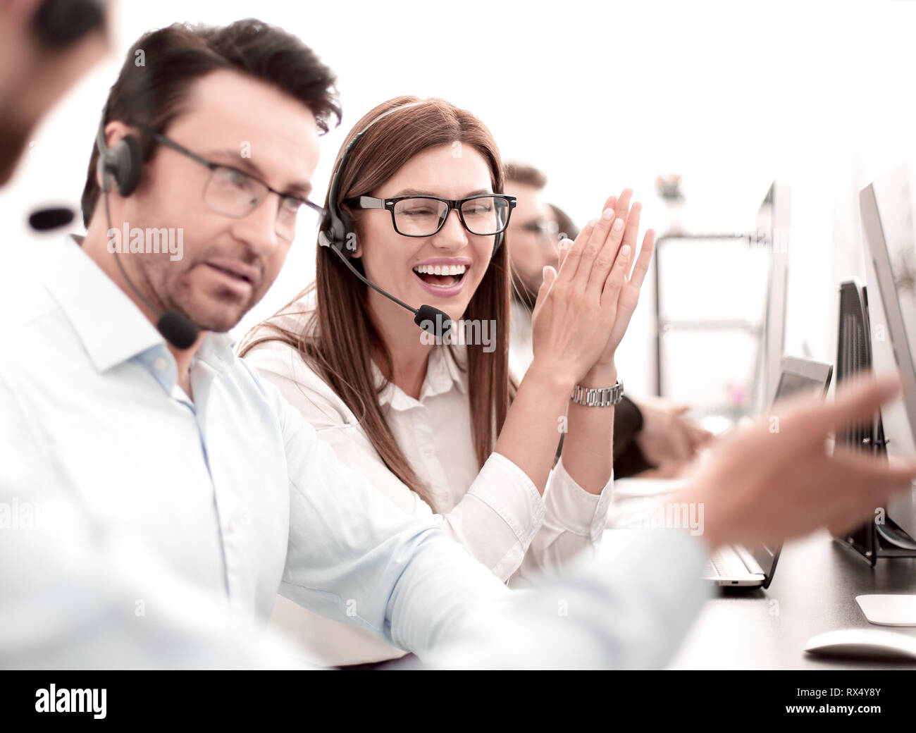 happy call center employees sitting at their Desk Stock Photo - Alamy
