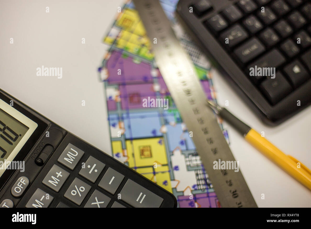 Top view of calculator, pen and ruler on blueprint plan of architecture ...