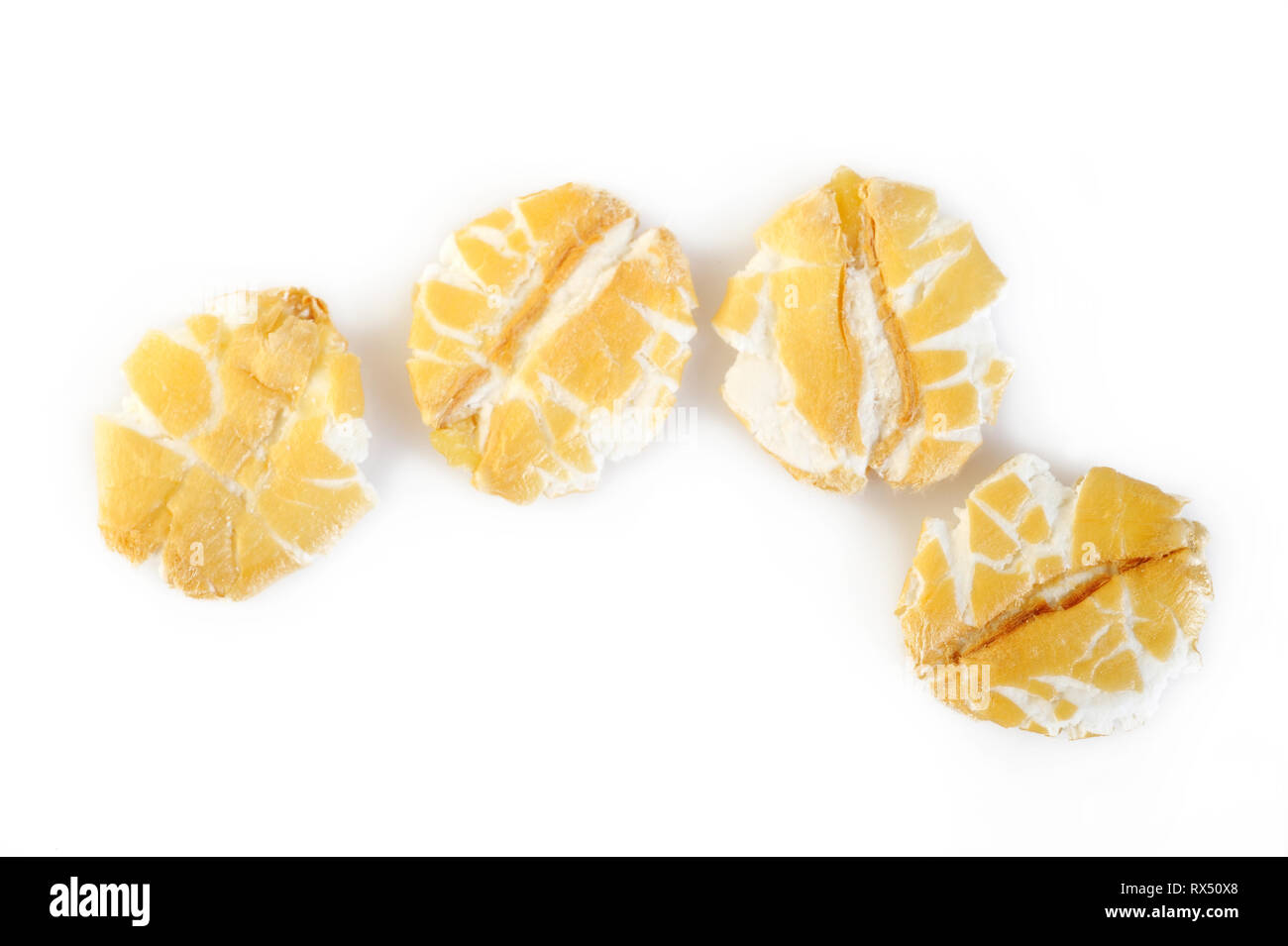 rolled wheat on white background Stock Photo - Alamy