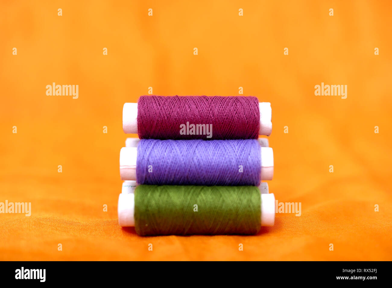 Picture of sewing thread. Isolated on the yellow background Stock Photo ...