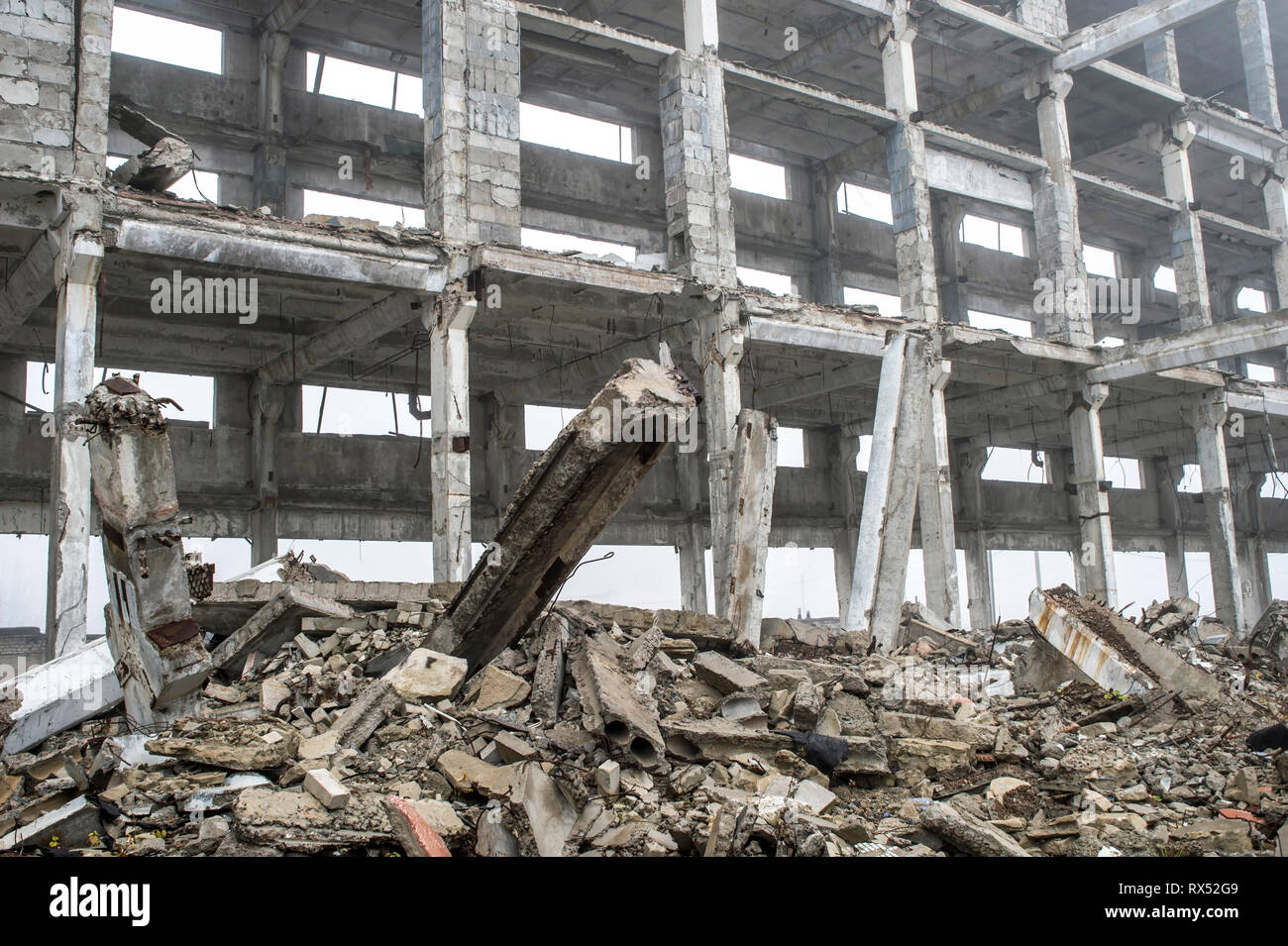 A huge concrete beam sticking out of a pile of concrete debris on the ...