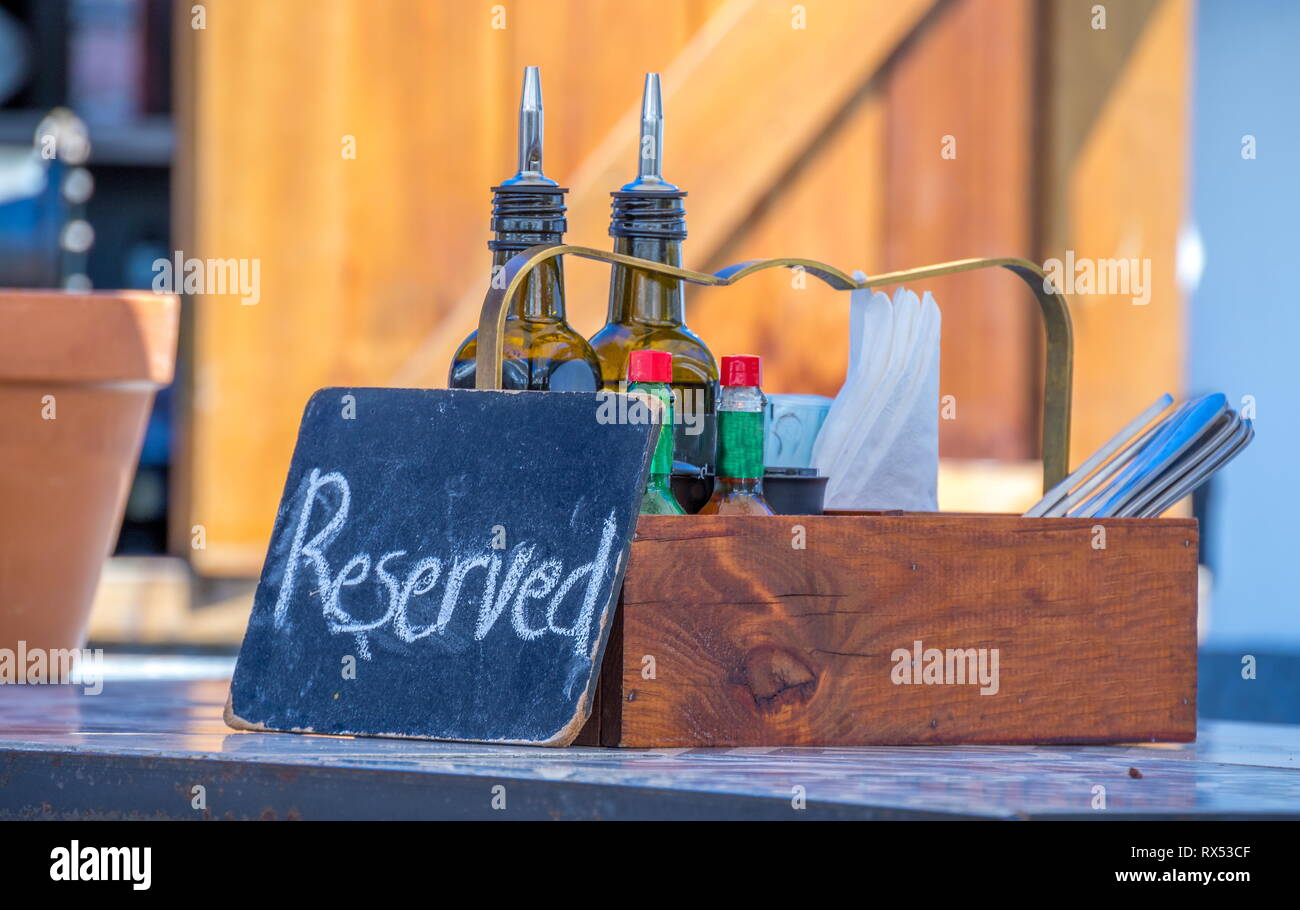 A table with a reserved sign on it in an outdoor cafe image in ...