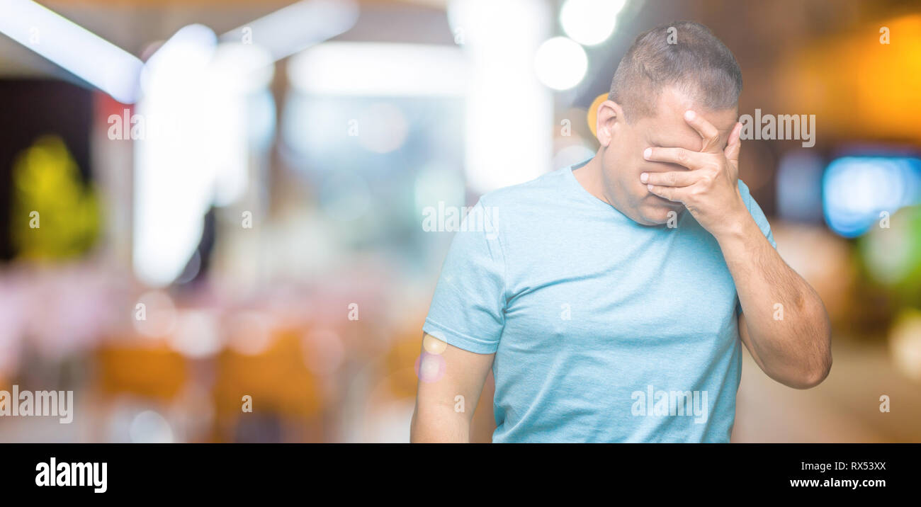 Middle age arab man wearing blue t-shirt over isolated background with ...