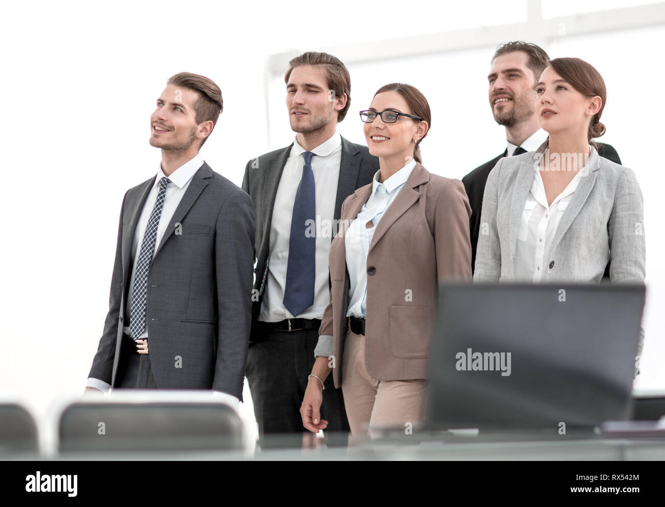 group of employees standing near the desktop Stock Photo - Alamy