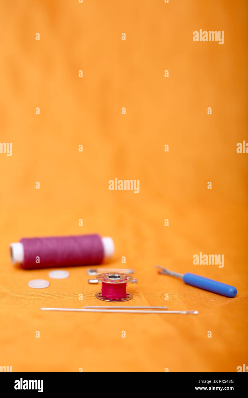 Picture of bobbin, thread, needle ripper, septic pin, button and needle ...