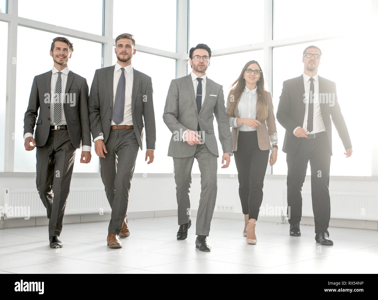 business team, walking at modern office interior Stock Photo - Alamy