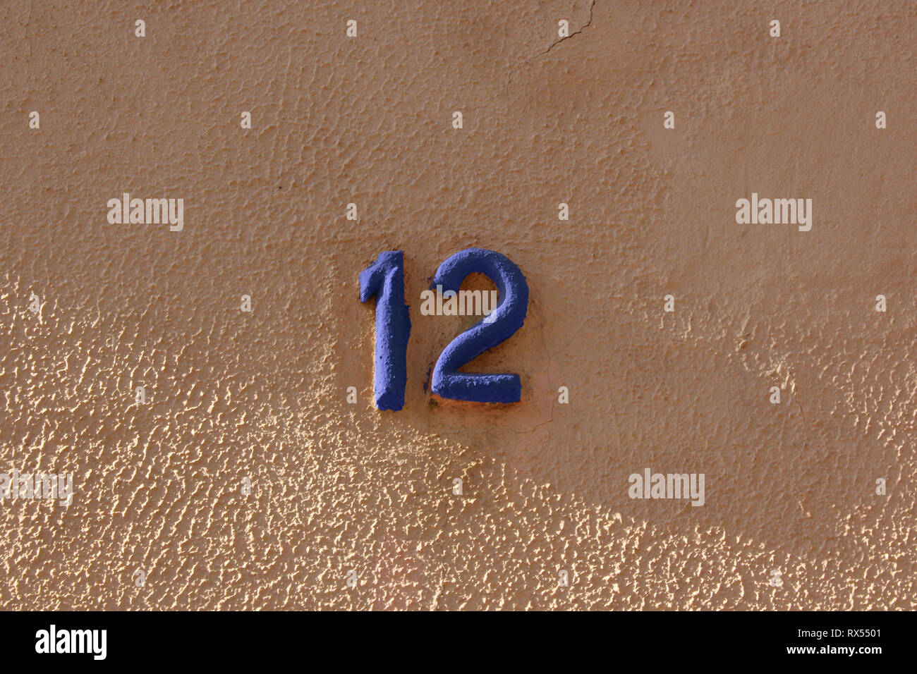 Number twelve street number high relief on wall Stock Photo - Alamy