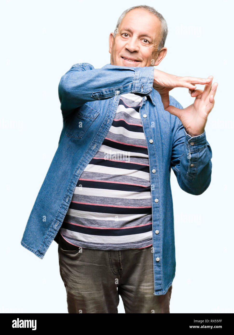 Handsome senior man wearing denim jacket smiling in love showing heart ...