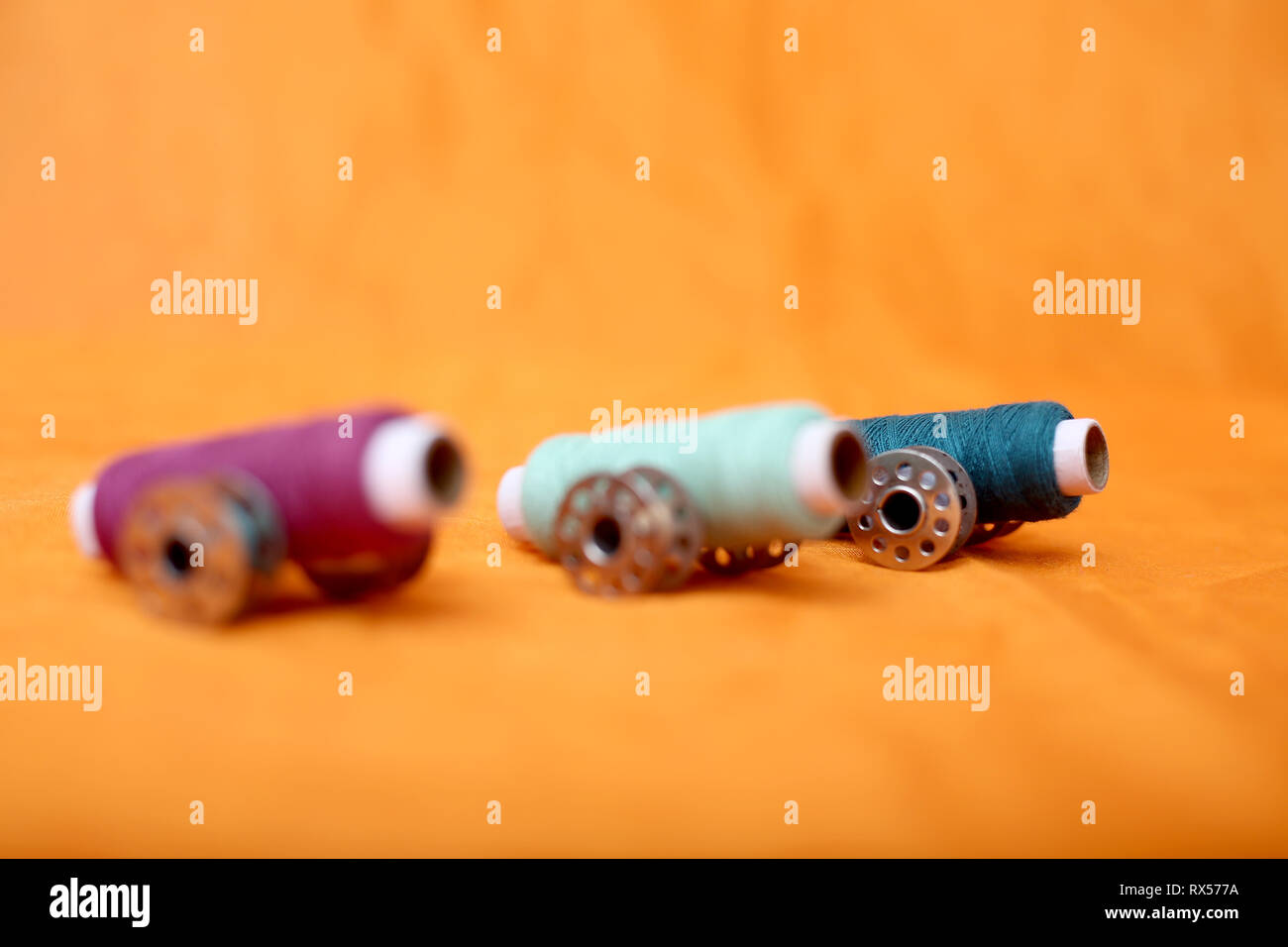 Photo of thread and bobbins. Isolated on the yellow background Stock ...