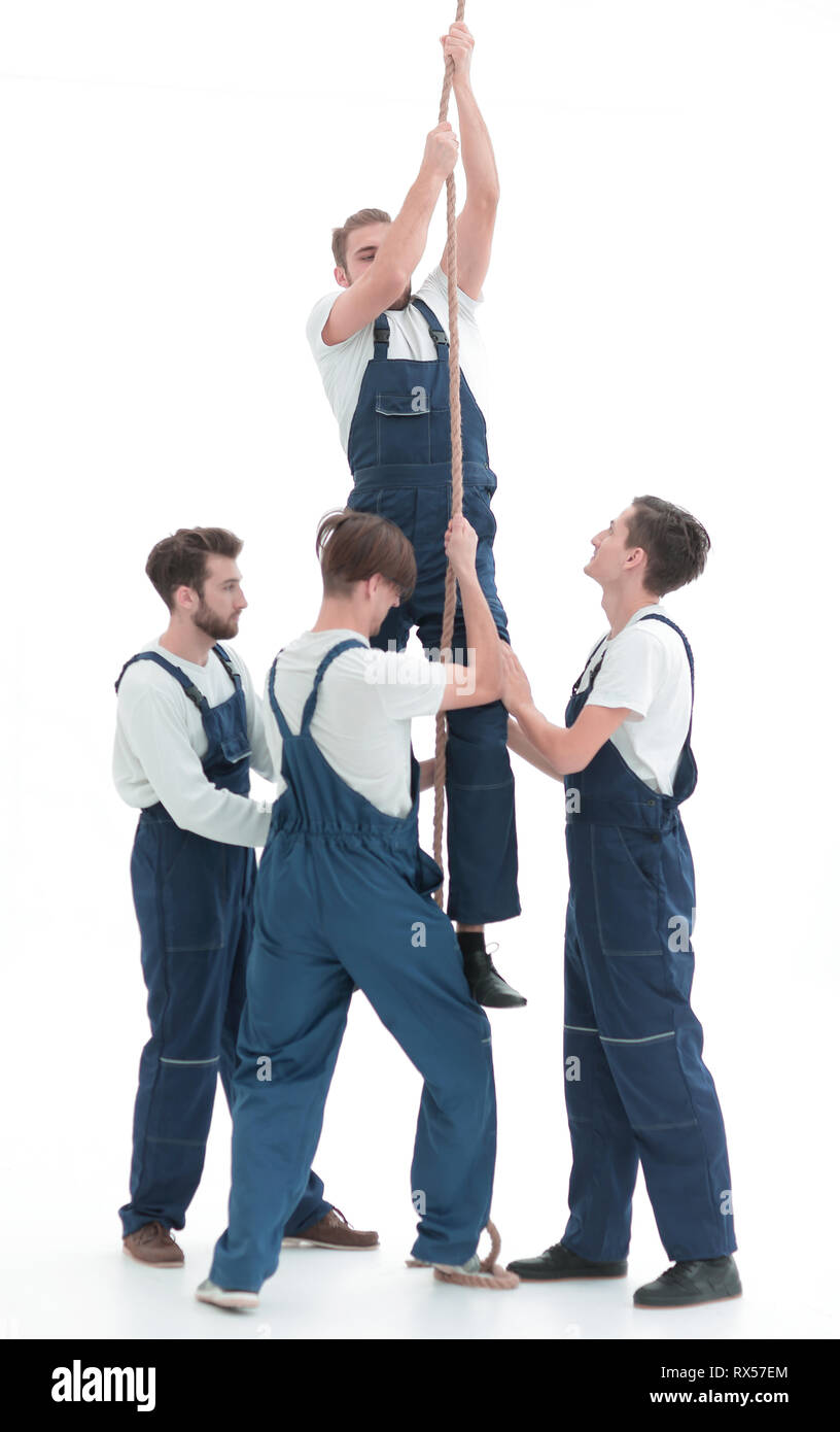 view from the top. team work in helping the leader to climb up Stock ...