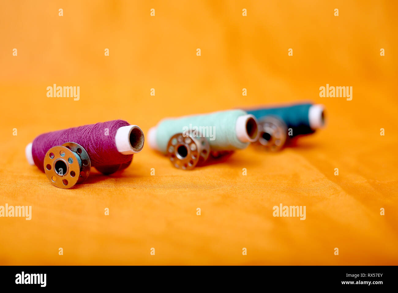 Portrait of thread and bobbins. Isolated on the yellow background Stock ...