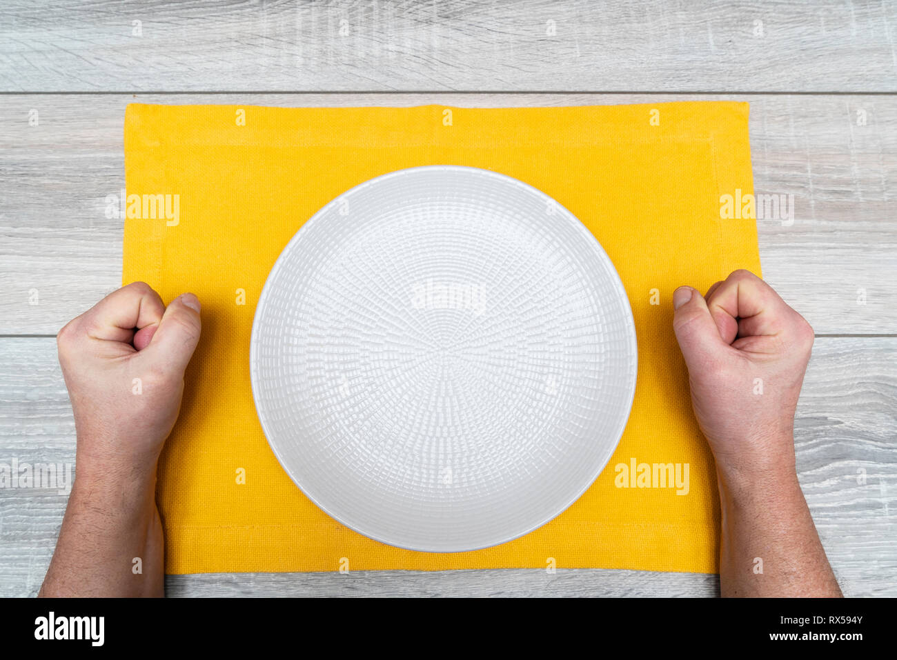 Hungry man empty plate hi-res stock photography and images - Alamy