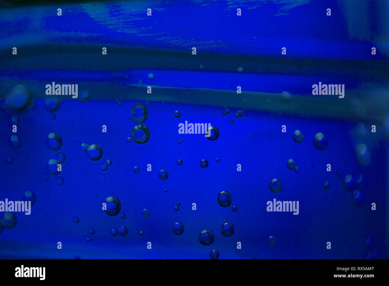 Different bubbles in a blue oil liquid, close-up Stock Photo - Alamy