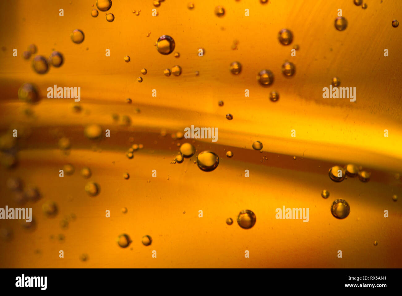 Different bubbles in a yellow oil liquid, close-up Stock Photo - Alamy