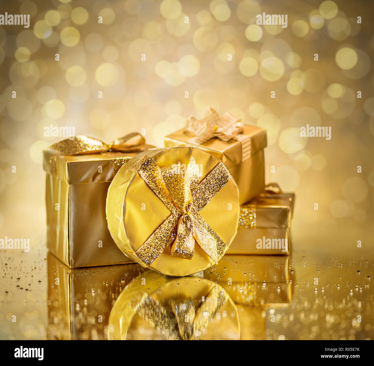 Golden gift boxes as a symbol of wishes and celebration. Golden blurred ...