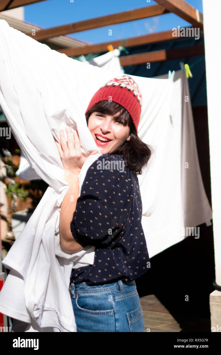 beautiful laughing french woman with woolly hat embraces her drying ...