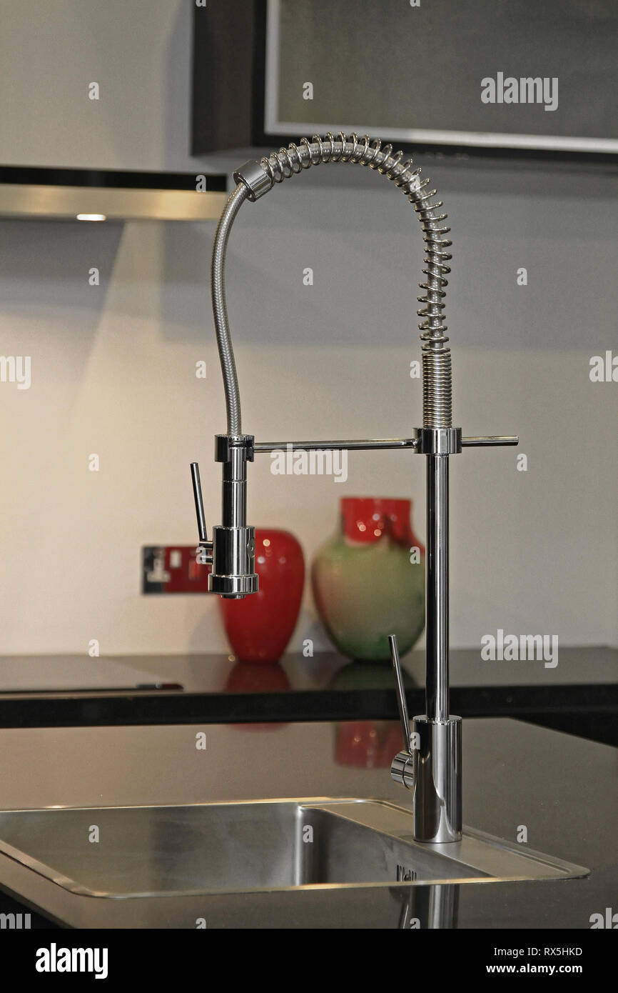 Stainless Steel Faucet With Spring in Modern Kitchen Stock Photo - Alamy