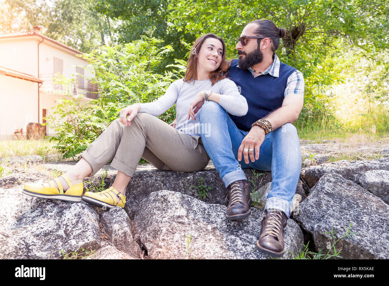 romantic couple relaxing on the banks of a river in summer Stock Photo ...