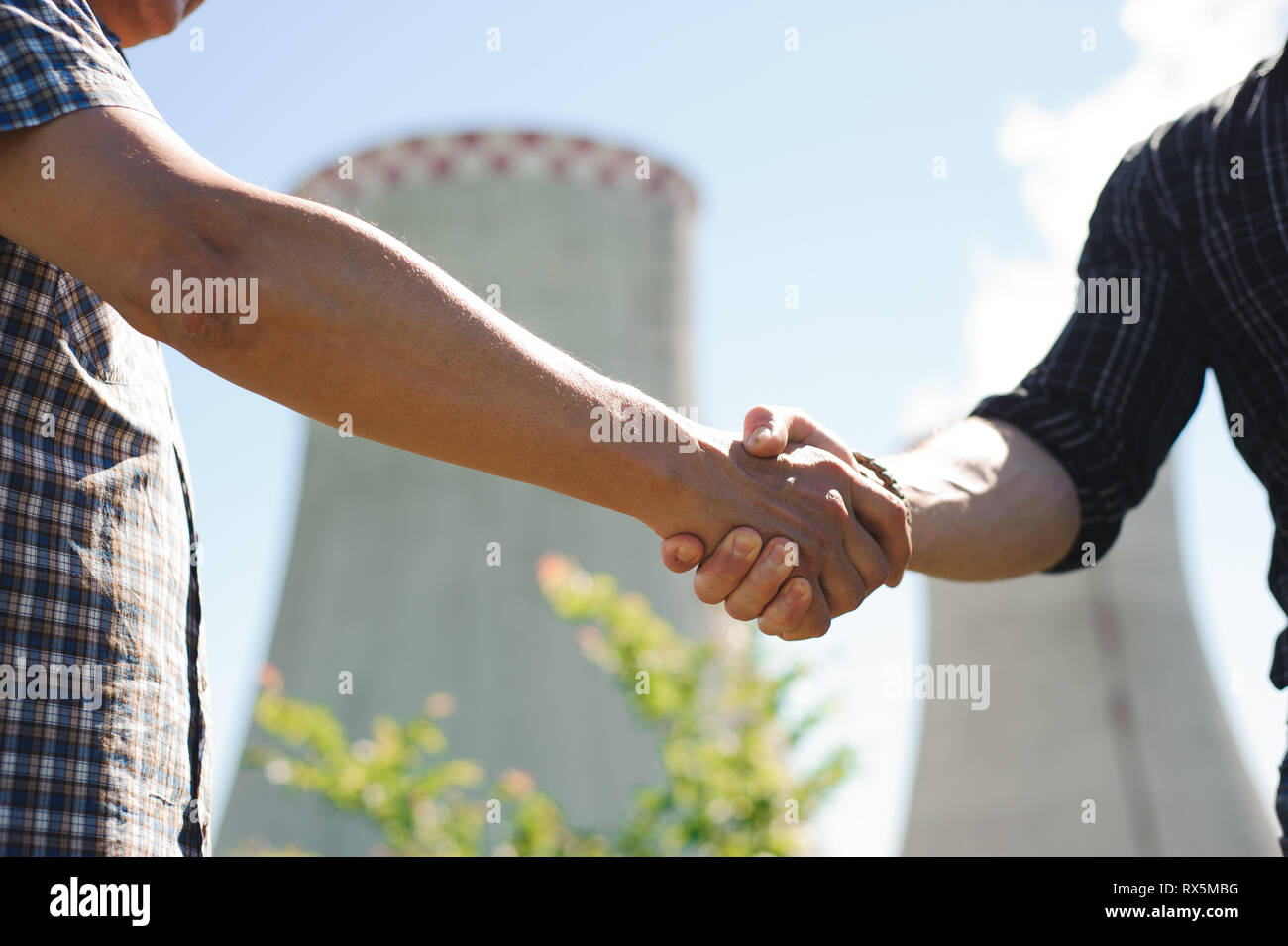 two power line tower workers with handshaking Stock Photo - Alamy
