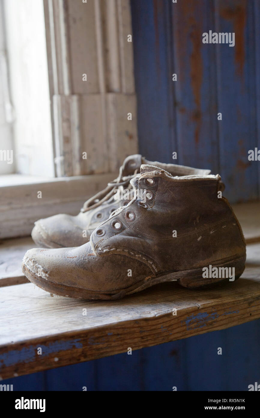 Old worn boots on the floor Stock Photo - Alamy