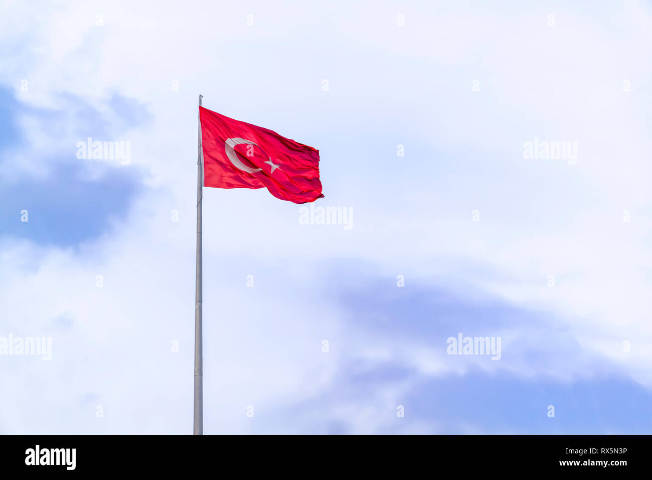 A huge Turkish flag waving in blue sky Stock Photo - Alamy